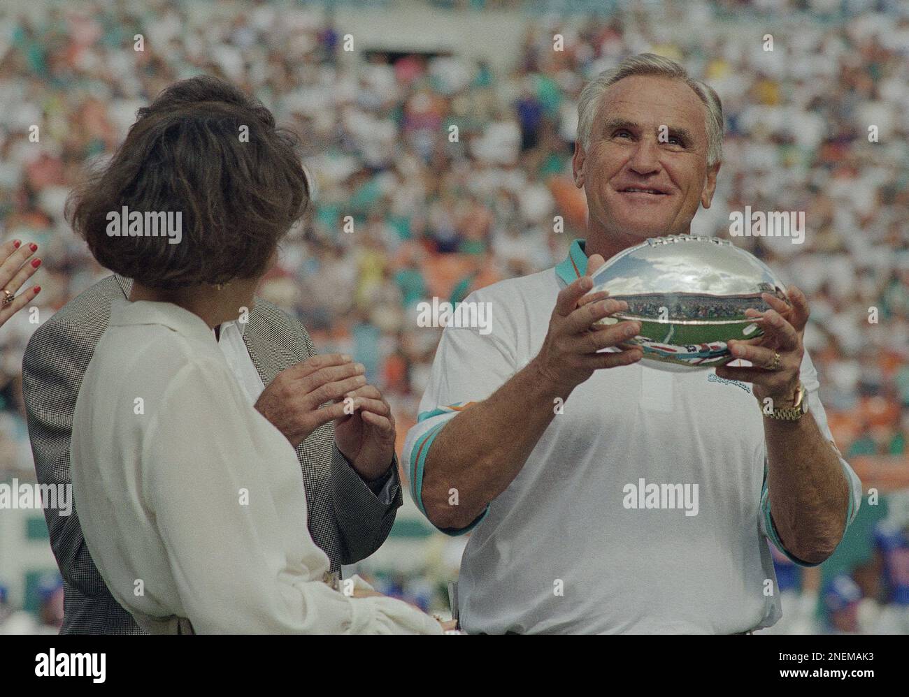 Miami Dolphin?s coach Don Shula holds up a silver football which was ...