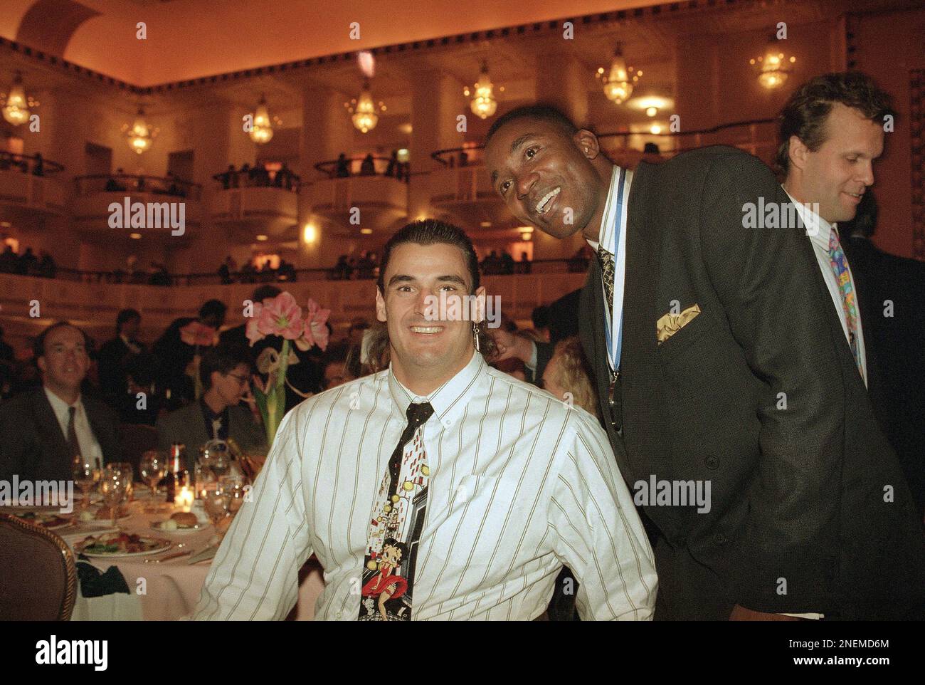Former Detroit Lions offensive lineman Mike Utley, left, poses with ...