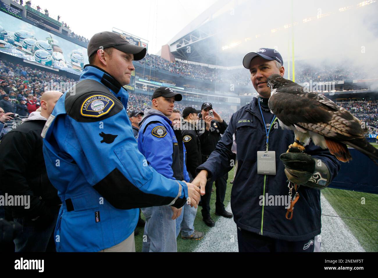 Lakewoood Police officers shake hands with the handler of Taima the ...