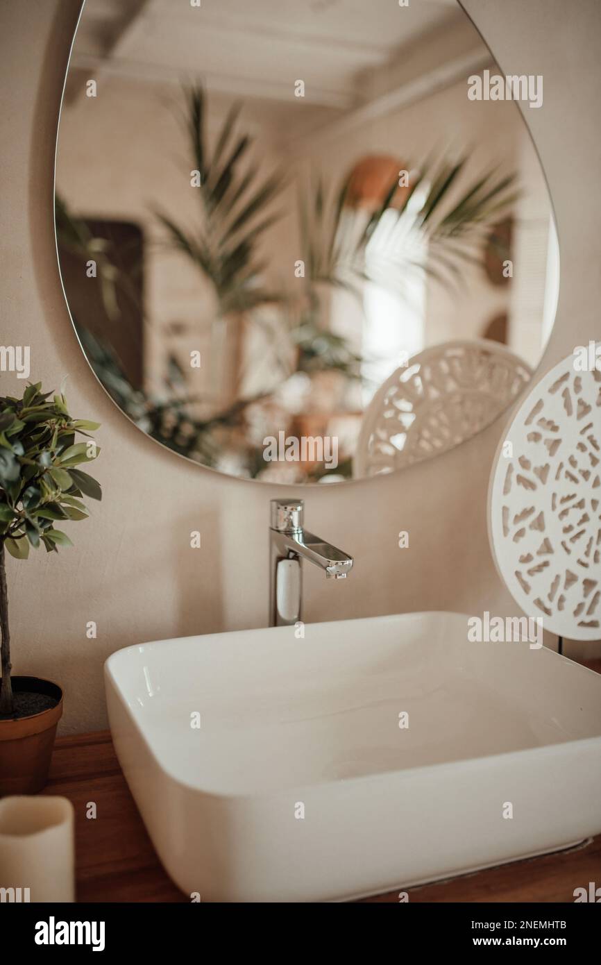 Soft native hues organic shapes look of bathroom with big window oval ...