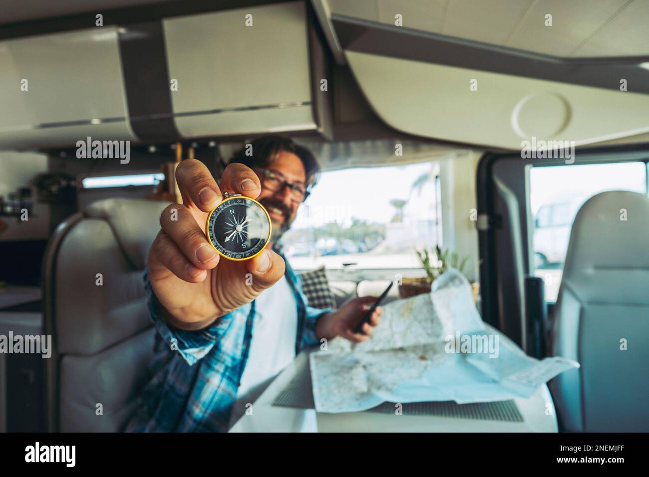 Travel and adventure lifestyle concept. One man showing compass at the ...