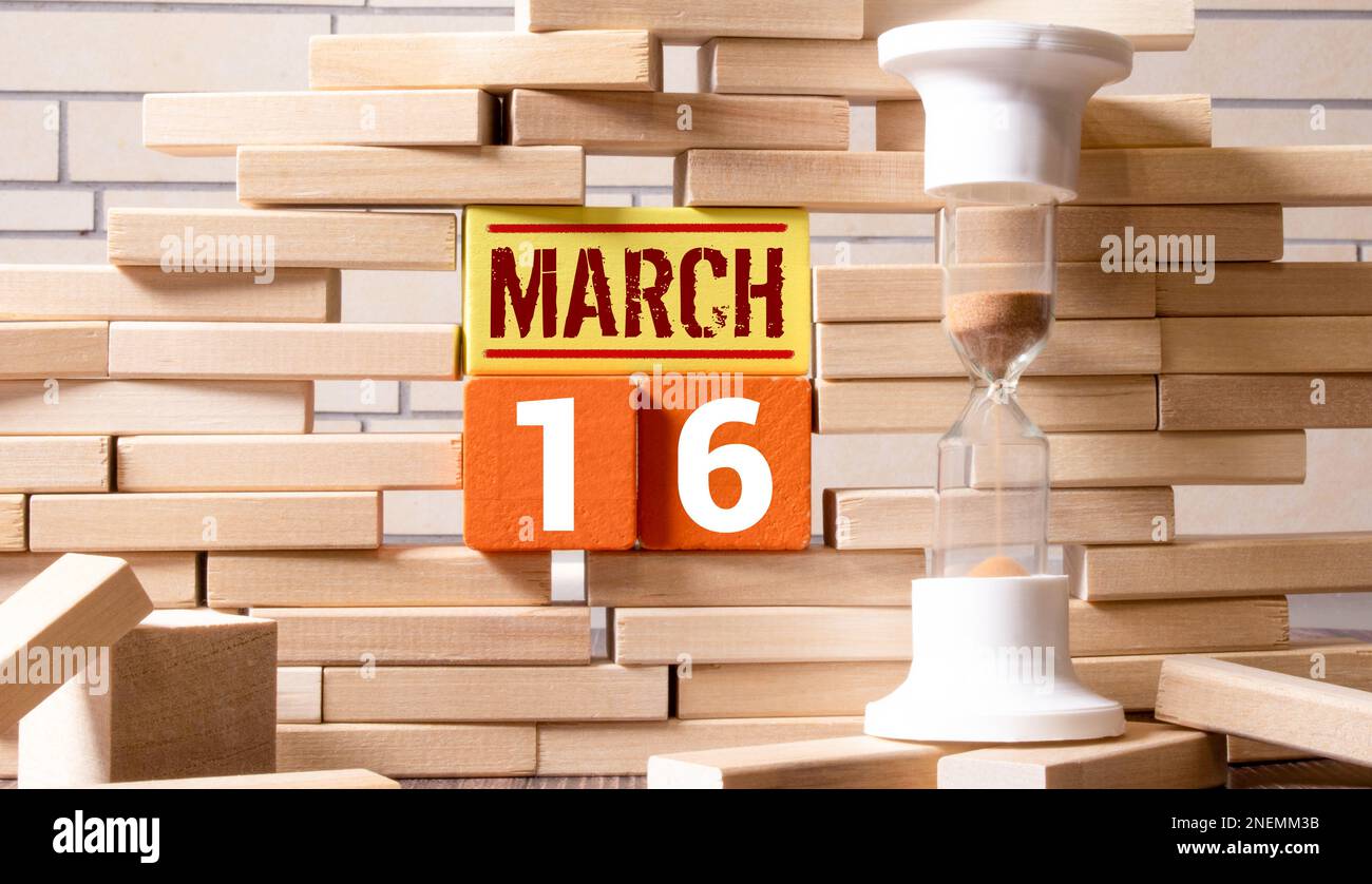 March 16 calendar date text on wooden blocks with blurred park ...