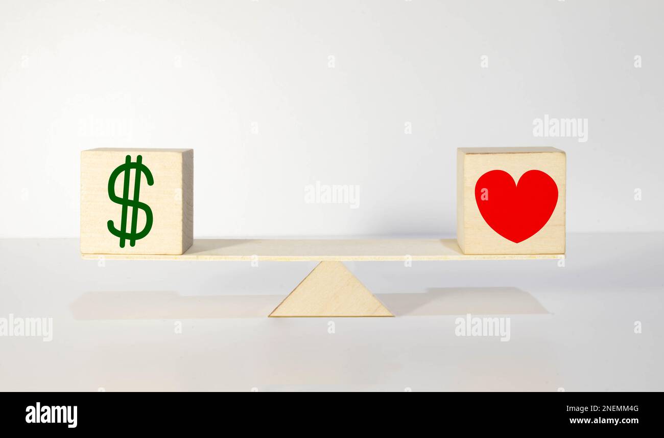 Heart and money on balance scale - Order of priority in life among love ...