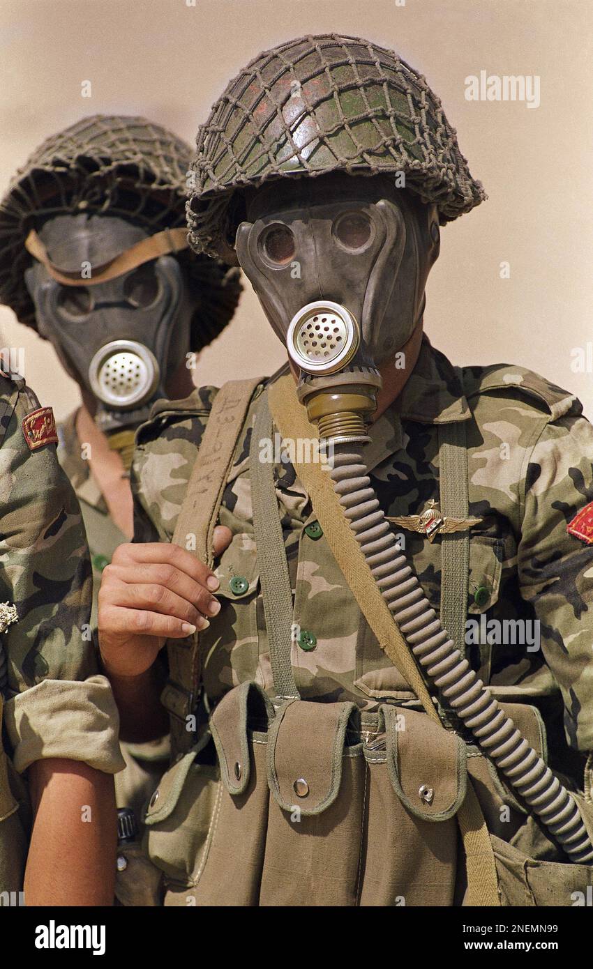 Syrian commandos wearing gas masks stand at attention at a Syrian army ...