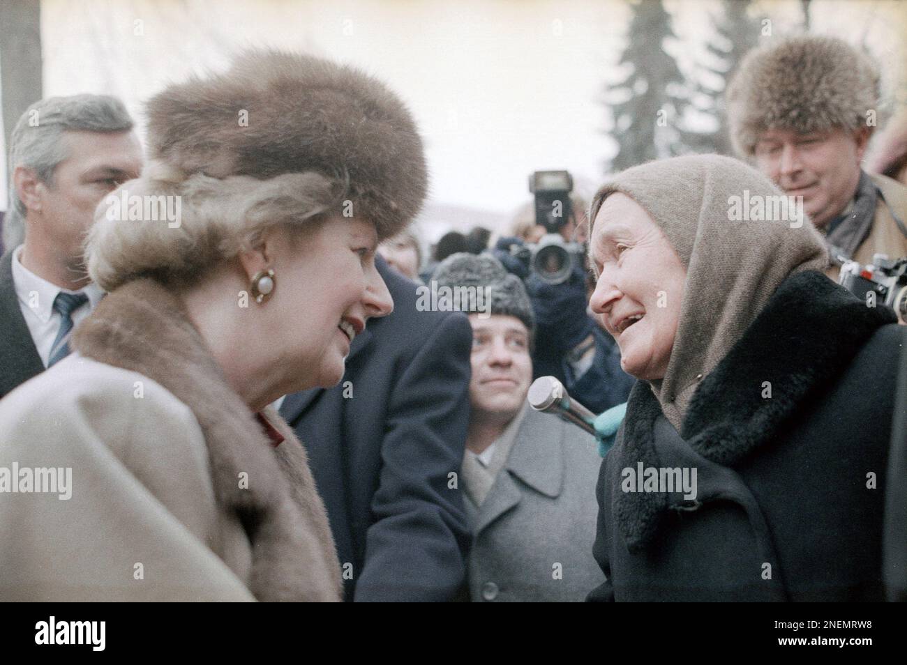 British Prime Minister Margaret Thatcher chats with an elderly woman ...