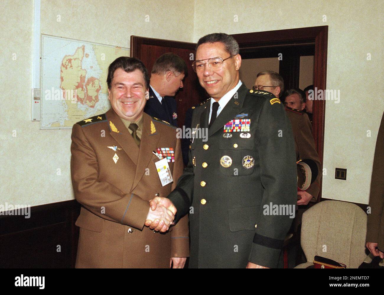 U.S. Chief of Staff General Colin Powell, right, shaking hands with ...