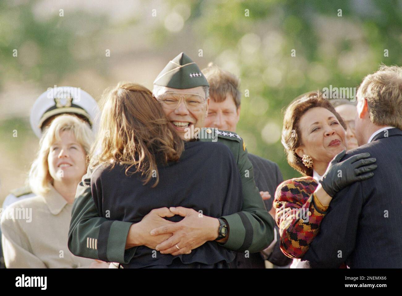Outgoing Joint Chiefs Chairman Gen. Colin Powell hugs Marilyn Quayle as ...