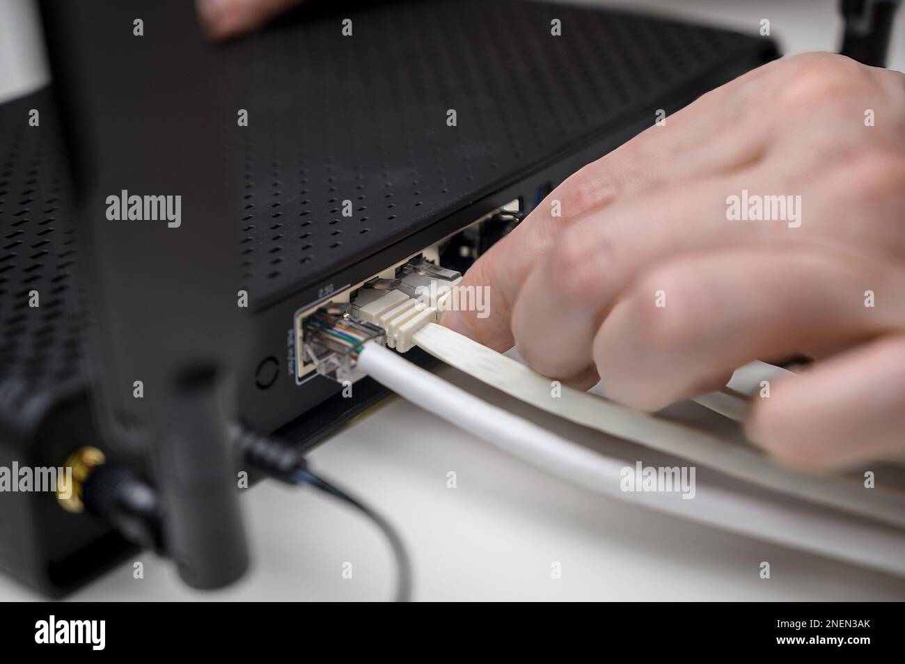 A Womans Hand Connects An Internet Cable To A Router Socket Fast And