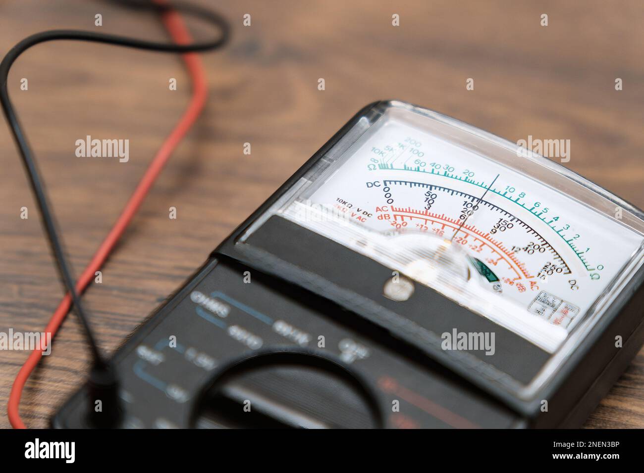 The close-up of the multimeter is on the table. measuring voltage with ...