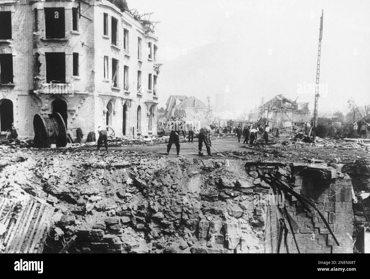 Debris is being cleared away by civilians and German troops in Rethel ...