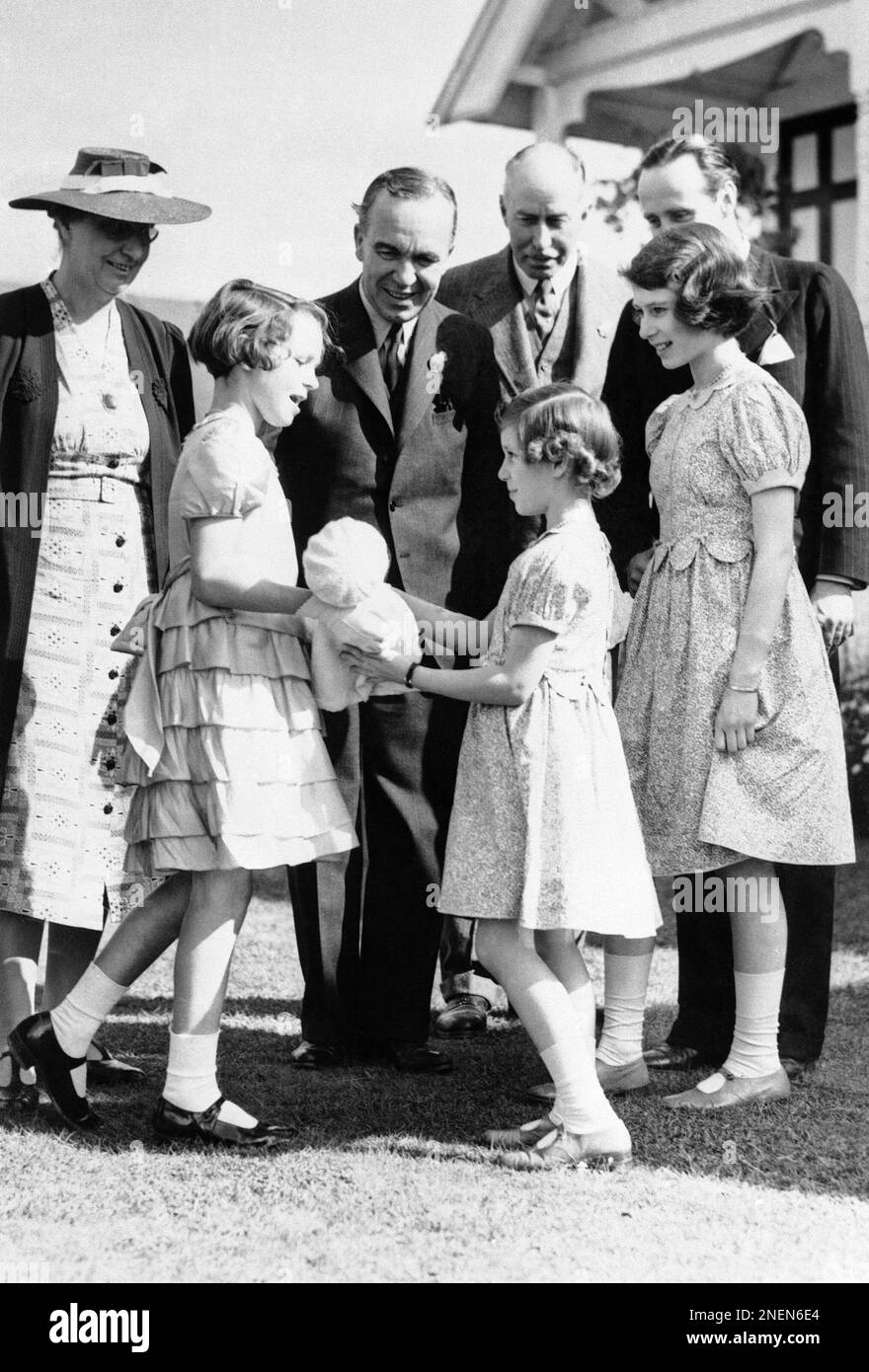 Joan Elizabeth Fossett (left) gives a curtsy as she presents a doll to ...