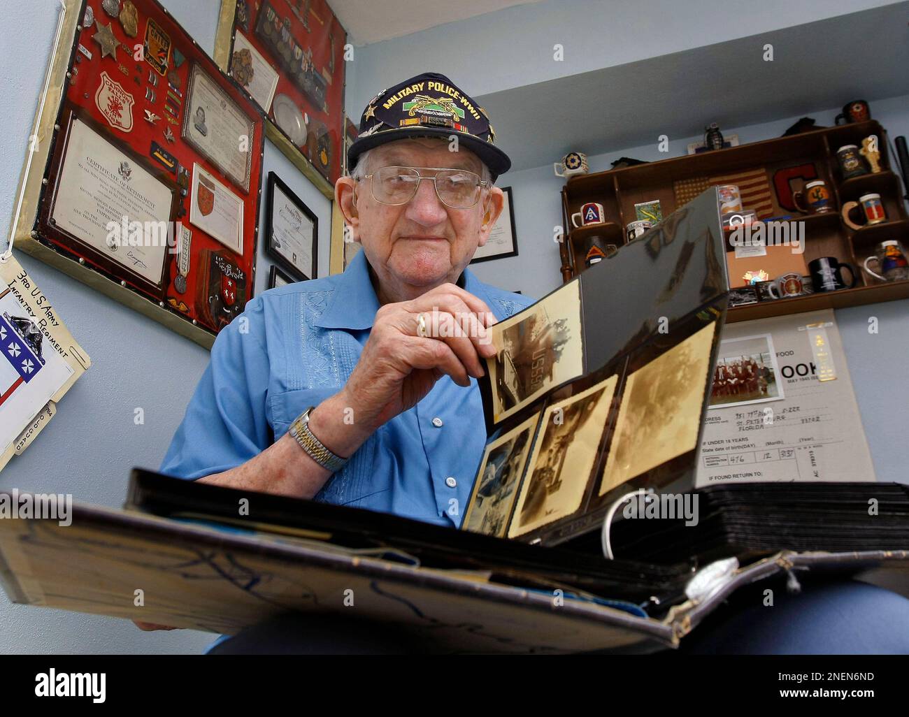 Bill Golden looks through a scrapbook of old photos Tuesday, Nov. 24 ...