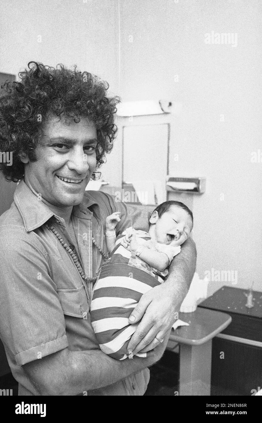 Yippie leader Abby Hoffman holds his son America (CQ) wrapped in an ...