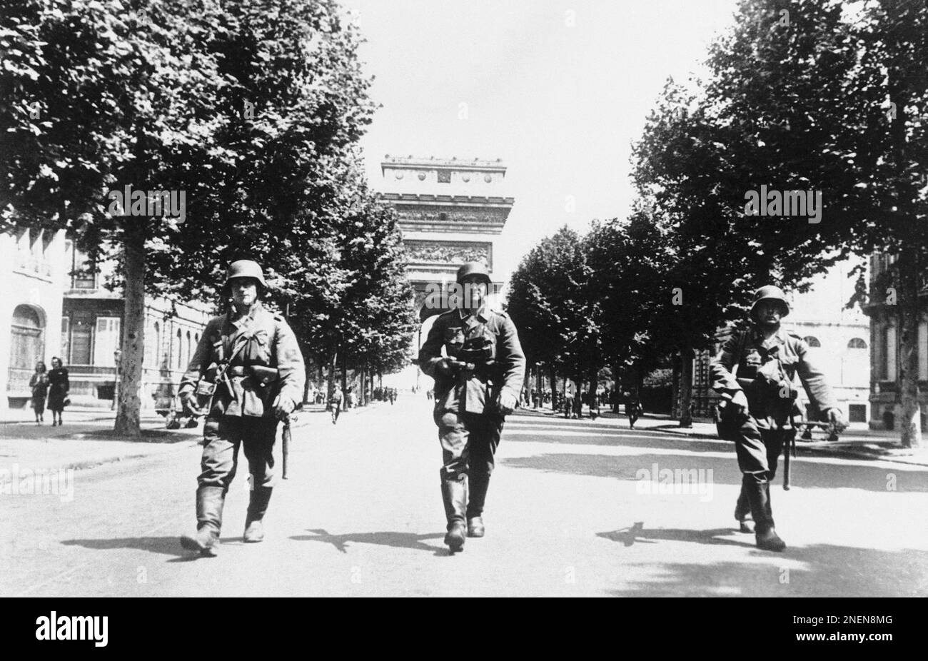 German troops march along the Champs-Elysees, with the Arc de Triomphe ...