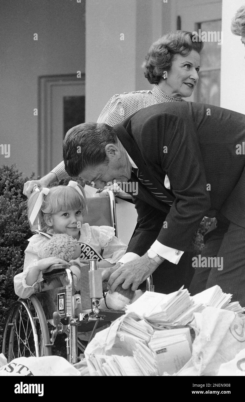 President Ronald Reagan signs a cast on the leg of the March of Diems ...