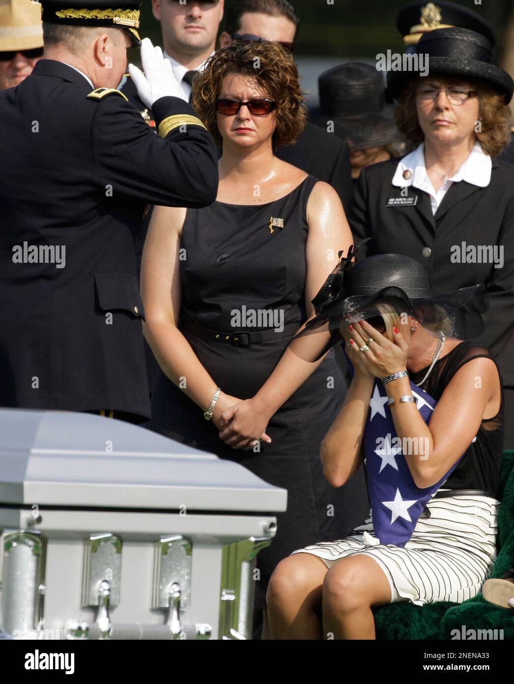 Rebecca L. Baldeosingh holds the flag from the casket with the remains ...