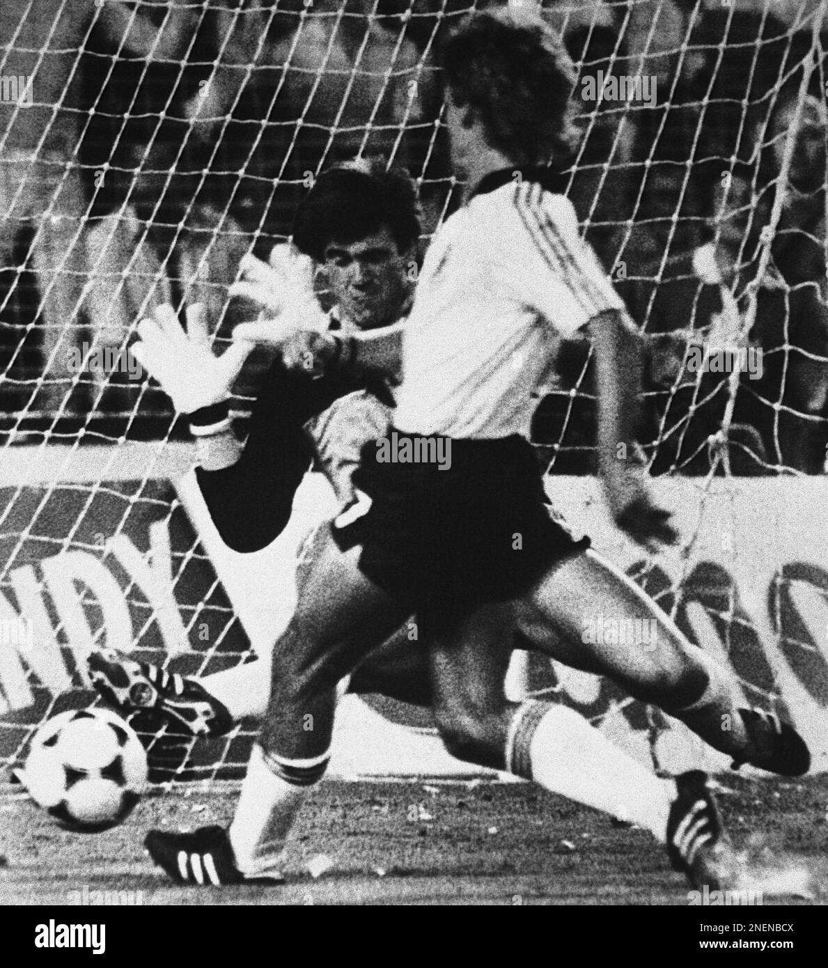 West Germany’s Pierre Littbarski hits the ball past Spanish goalkeeper ...