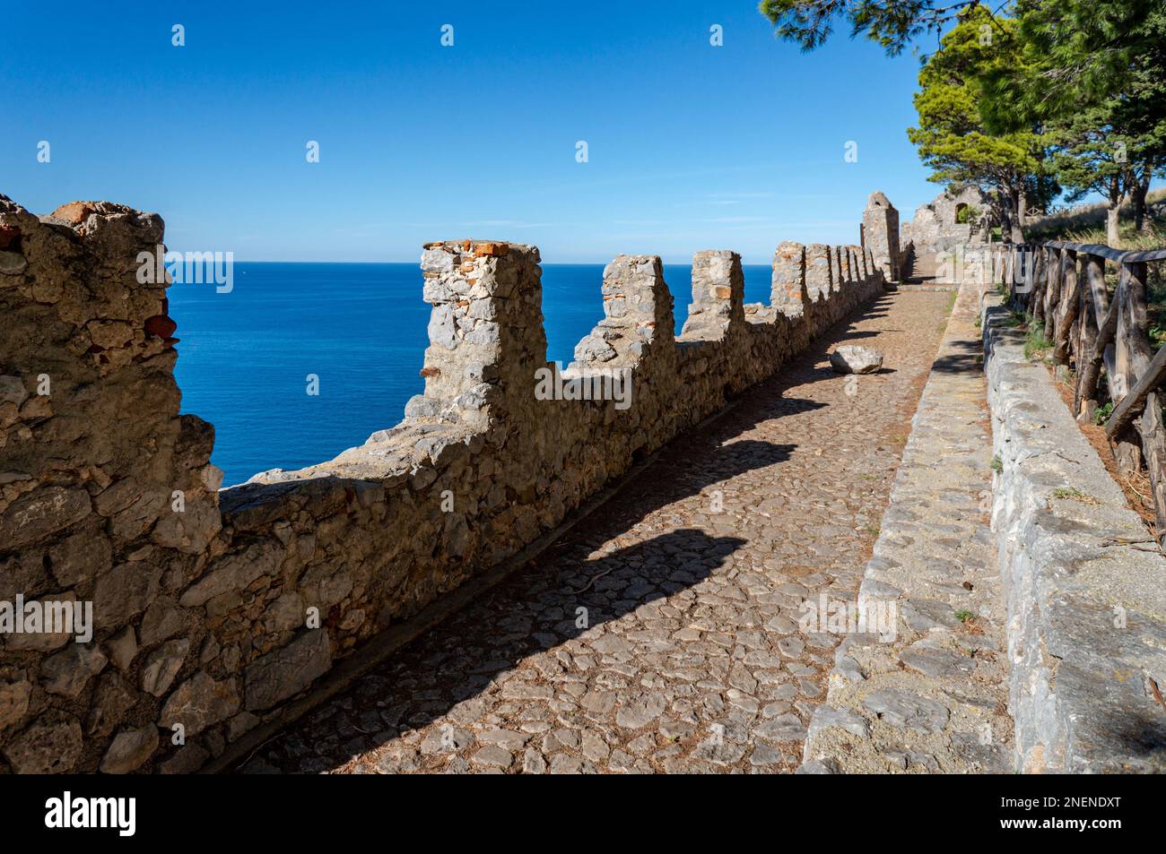 A beautiful shot of historic stone wall ruins near the water in Cefalu ...