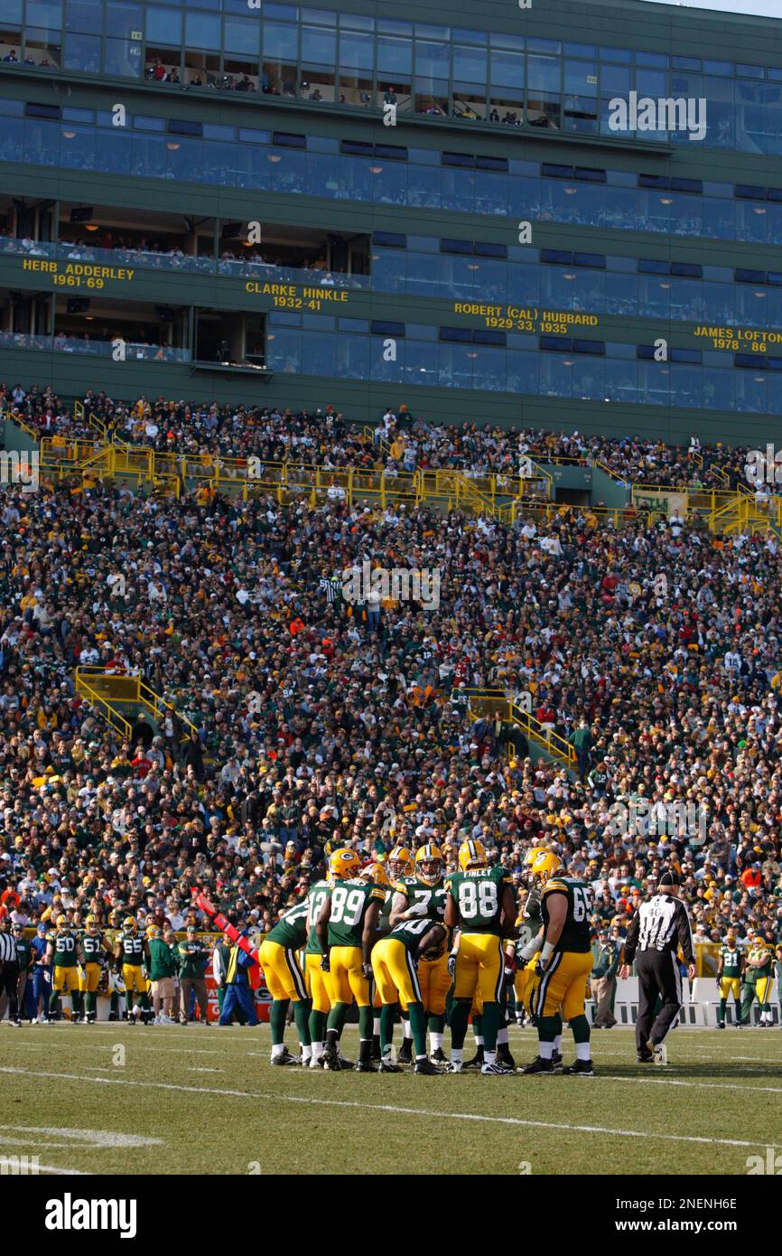 The Green Bay Packers huddle during the first half of an NFL football ...