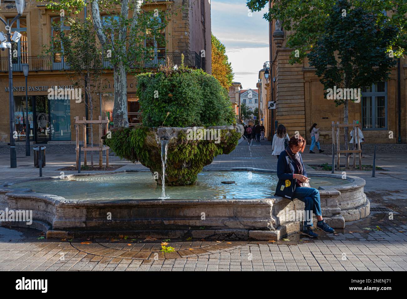 Woman sitting on the edge of one of the living fountains in Aux-in ...