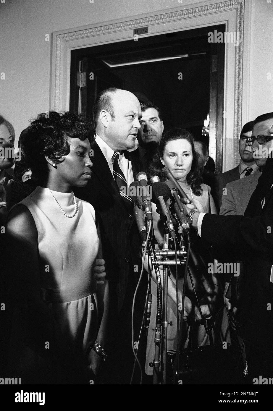 Secretary of Defense Melvin Laird, flanked by the wives of two ...