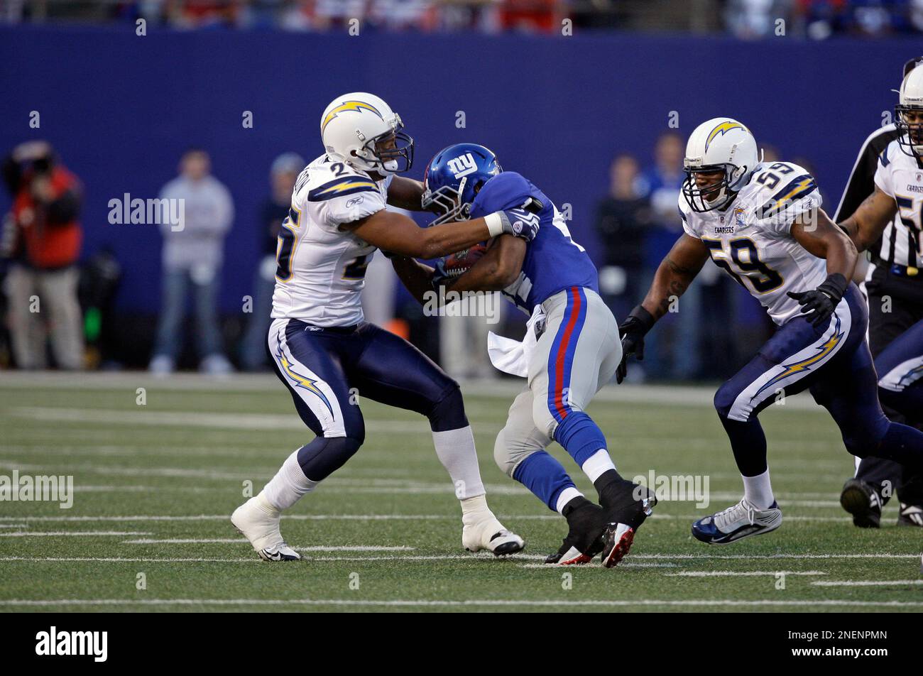 San Diego Chargers Kevin Ellison #25 tackles the New York Giants Ahmad ...