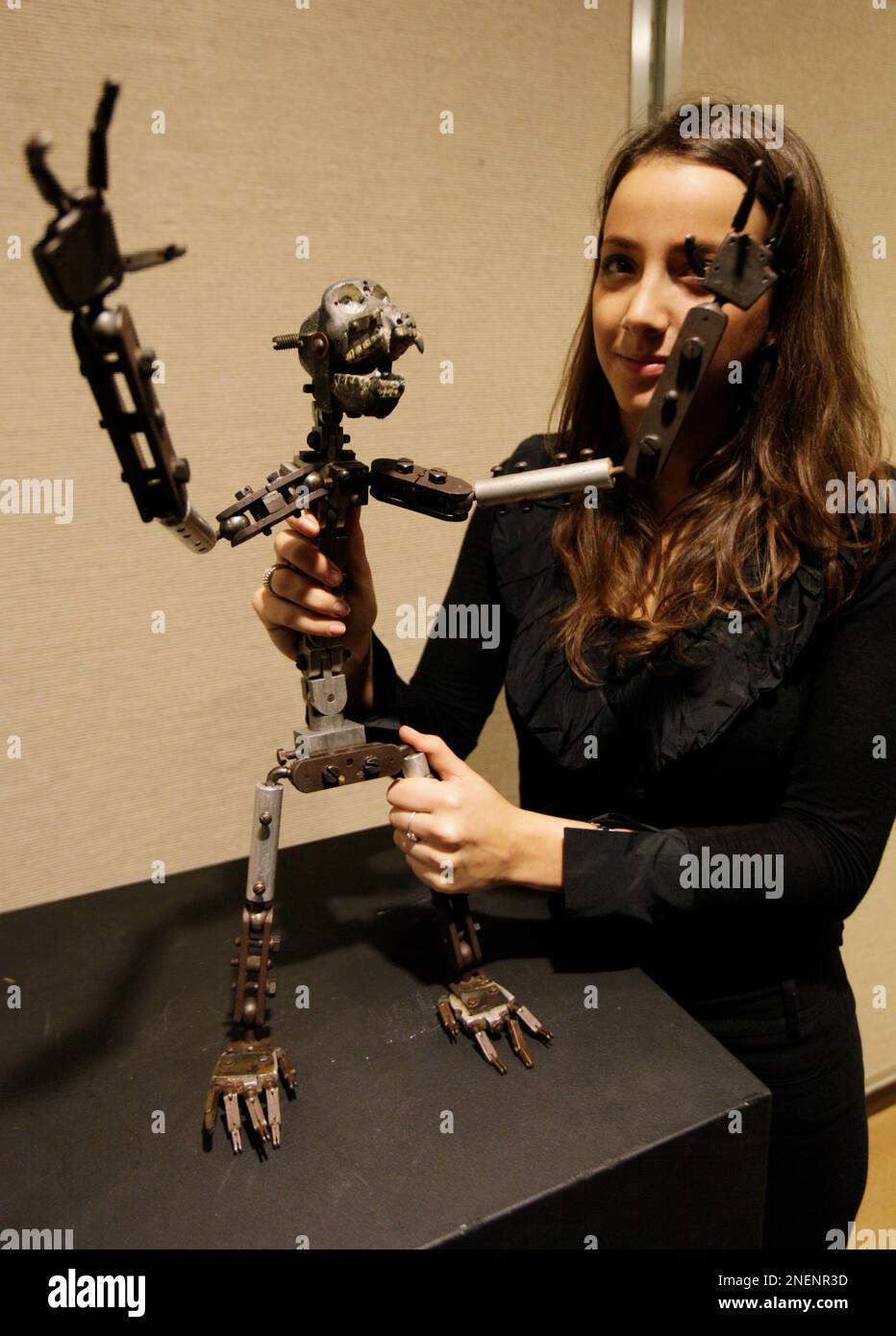 An auction house worker poses for the photographers as she holds the ...