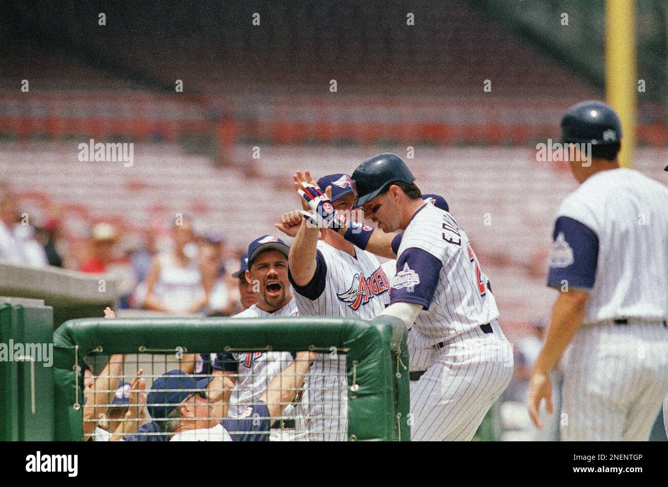 Anaheim Angels Jim Edmonds is greeted by cheering teammates after ...