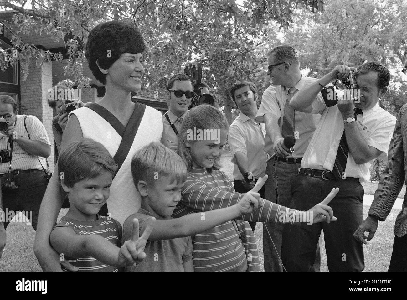 The Collins children, Ann, 7; Mike, 6; and Kate, 10; are instructed by ...