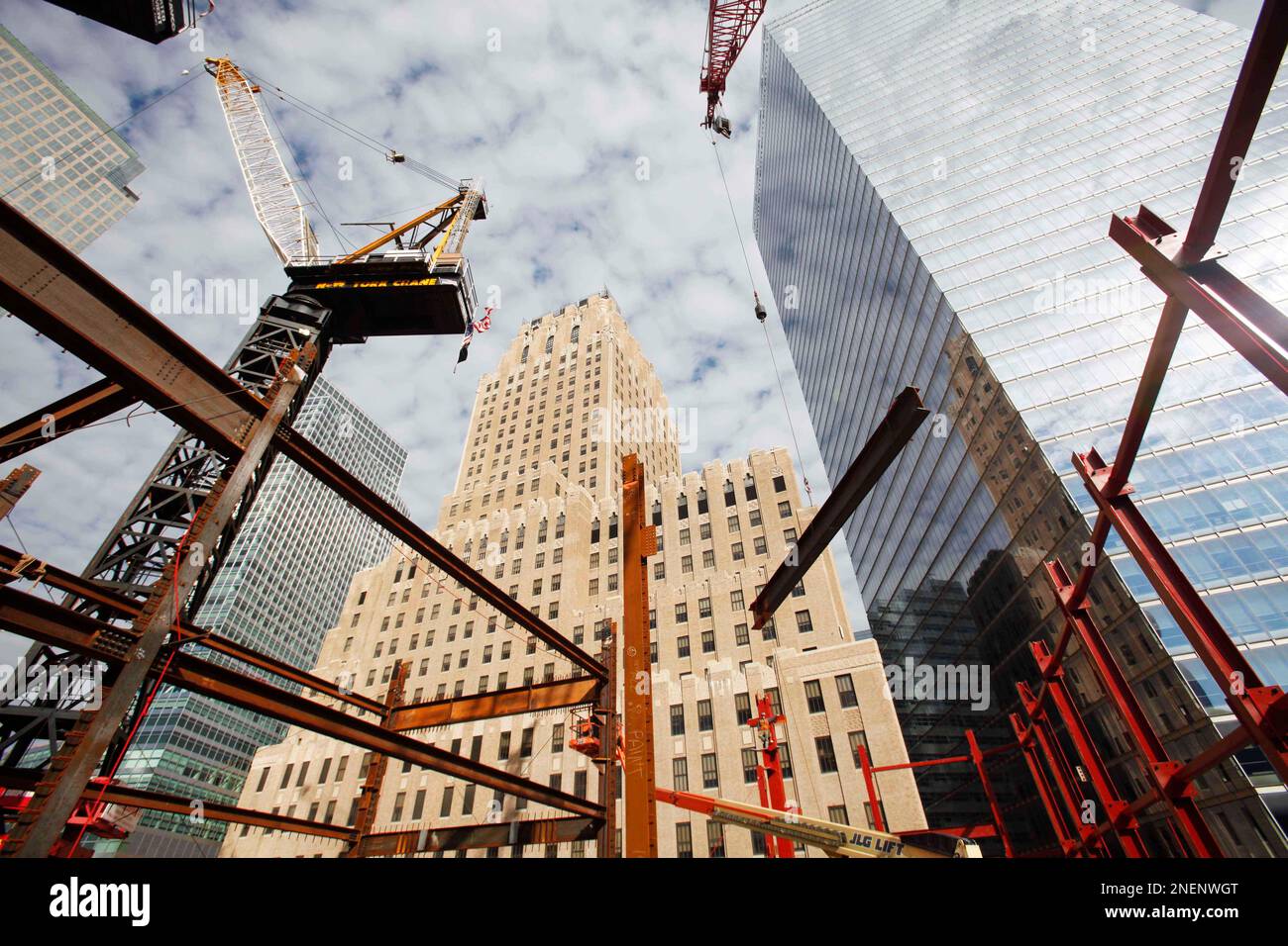 A crane hoists a steel beam to the rising frame of One World Trade ...