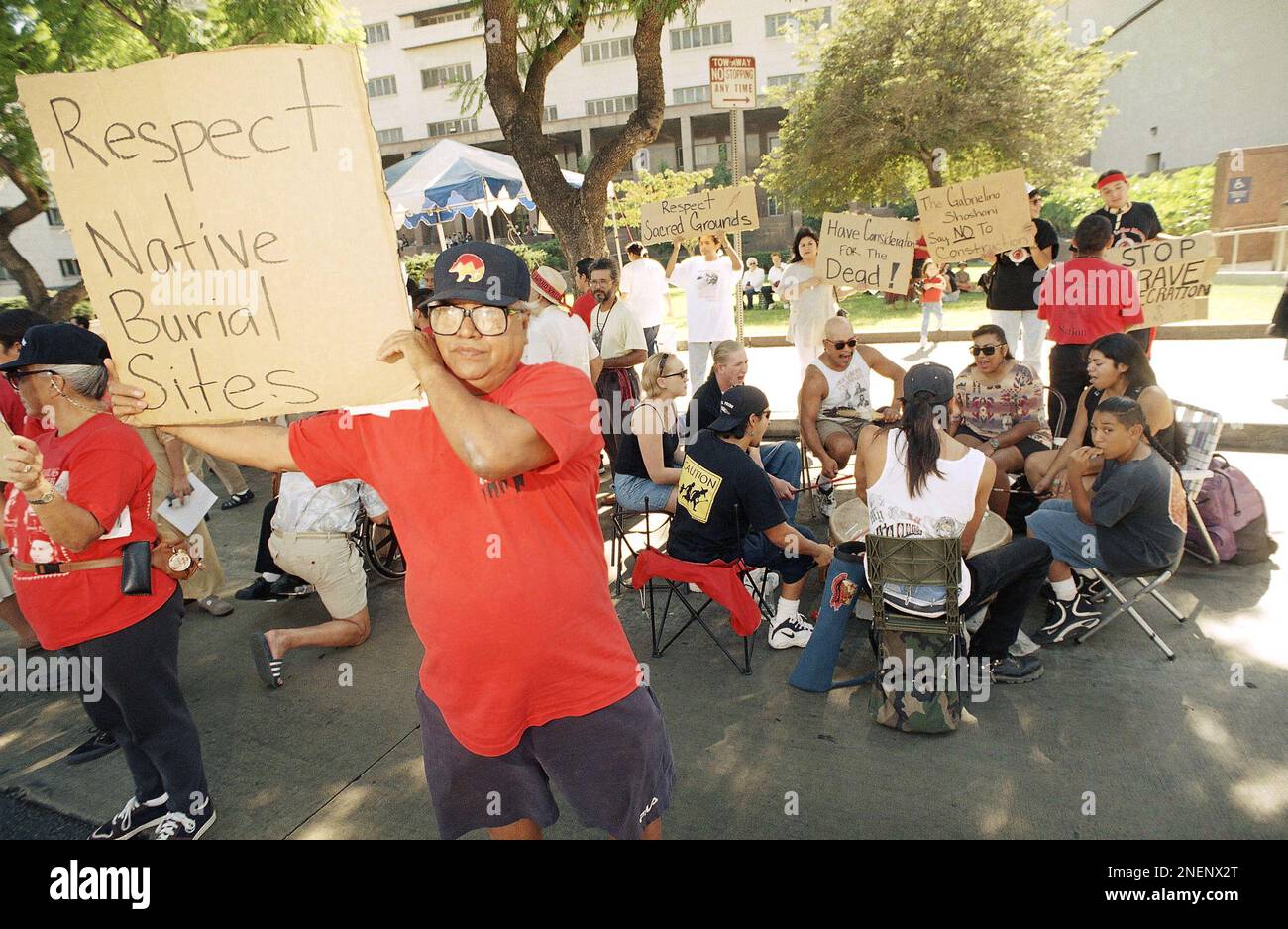 Paul Crow holds a sign as part of a protest by Indians before the start ...