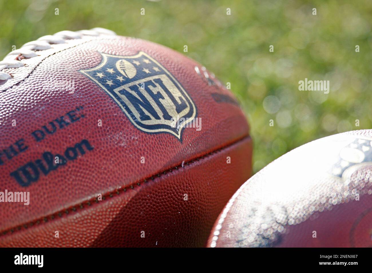 Two NFL footballs sit on the field prior to an NFL football game ...