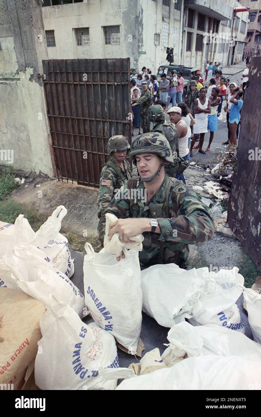 Members of the 82nd airborne division distribute food taken form the ...