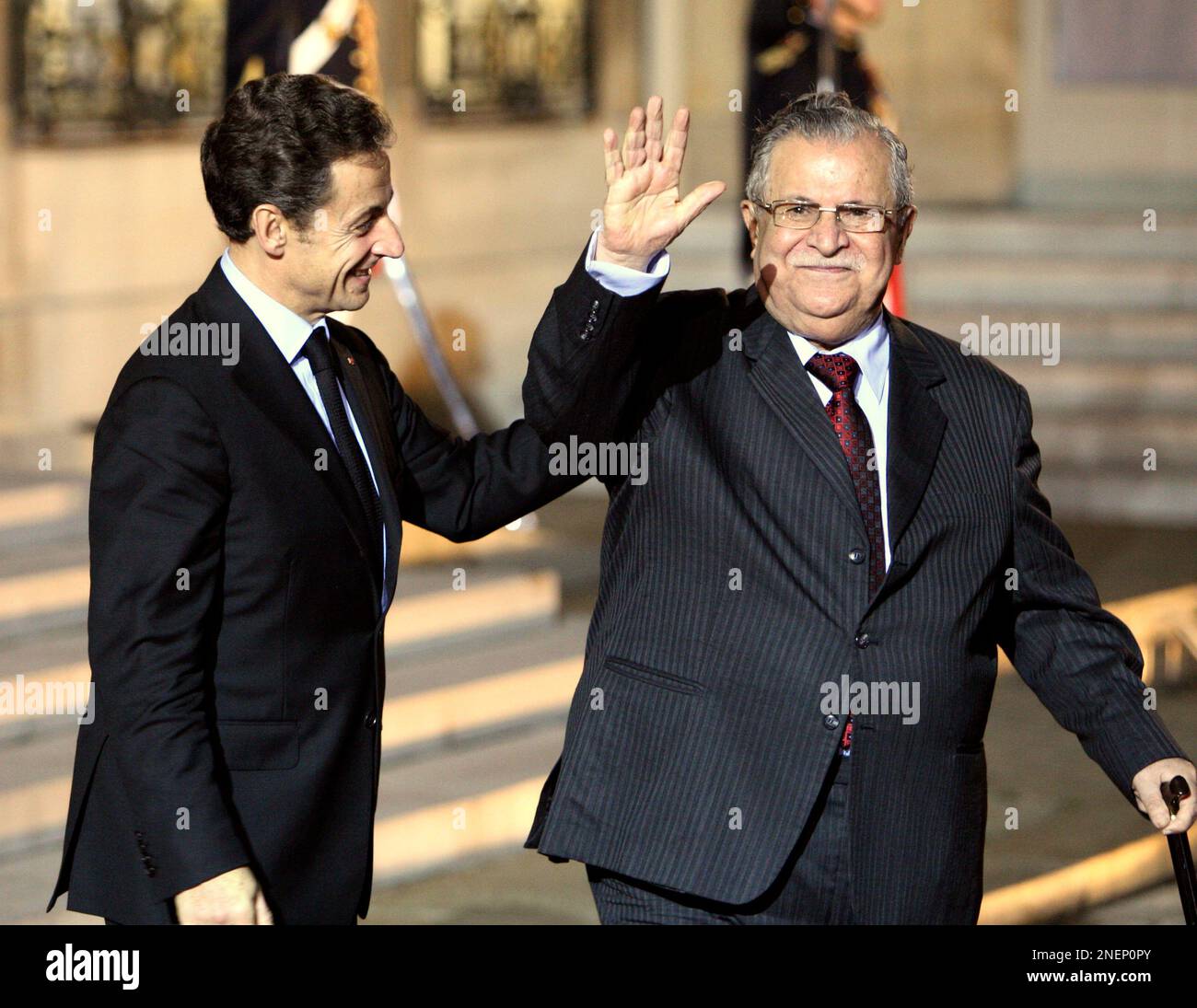 Iraqi President Jalal Talabani, right, gestures following his meeting ...