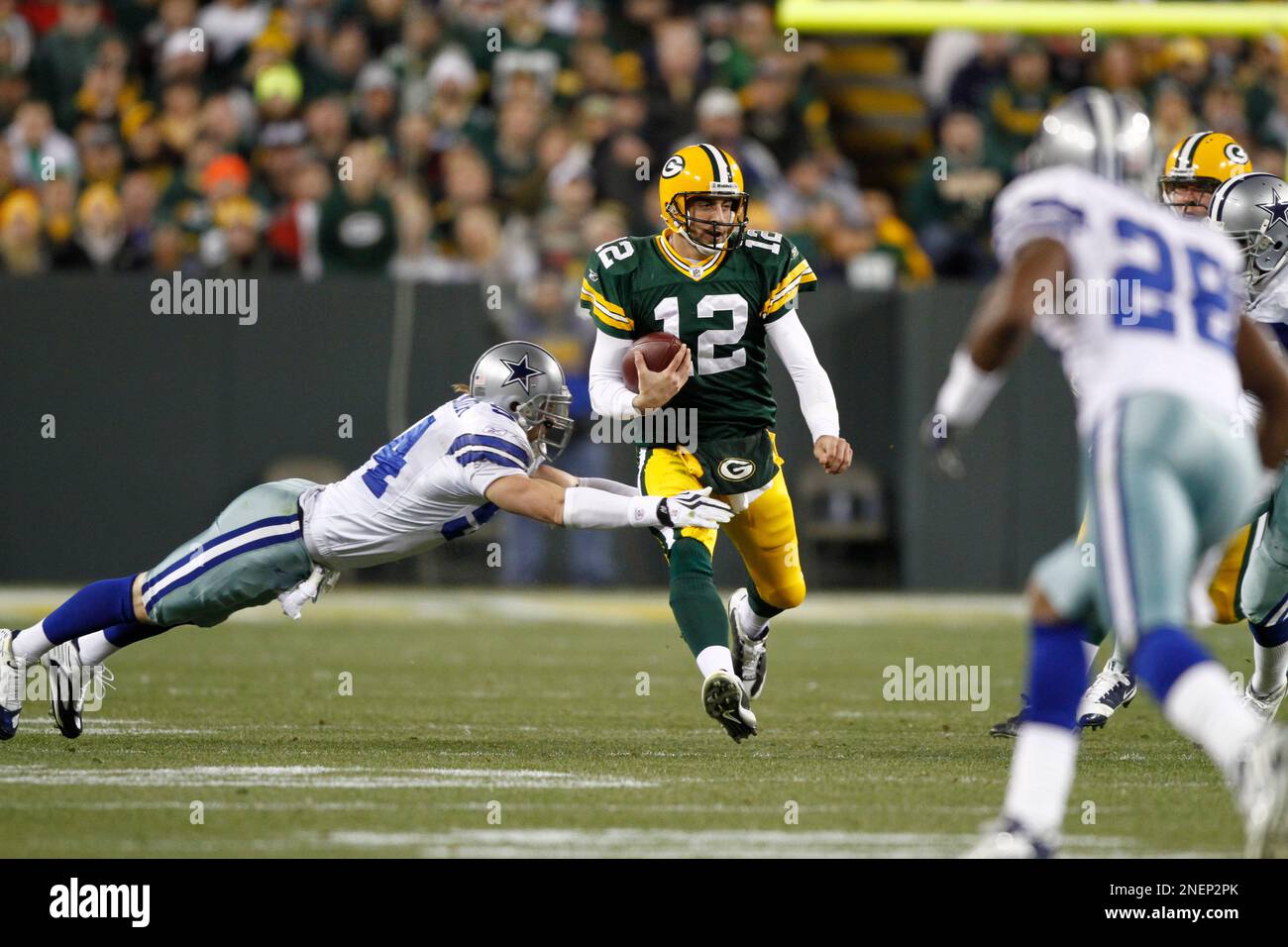 Green Bay Packers' Aaron Rodgers runs past Dallas Cowboys' Bobby ...