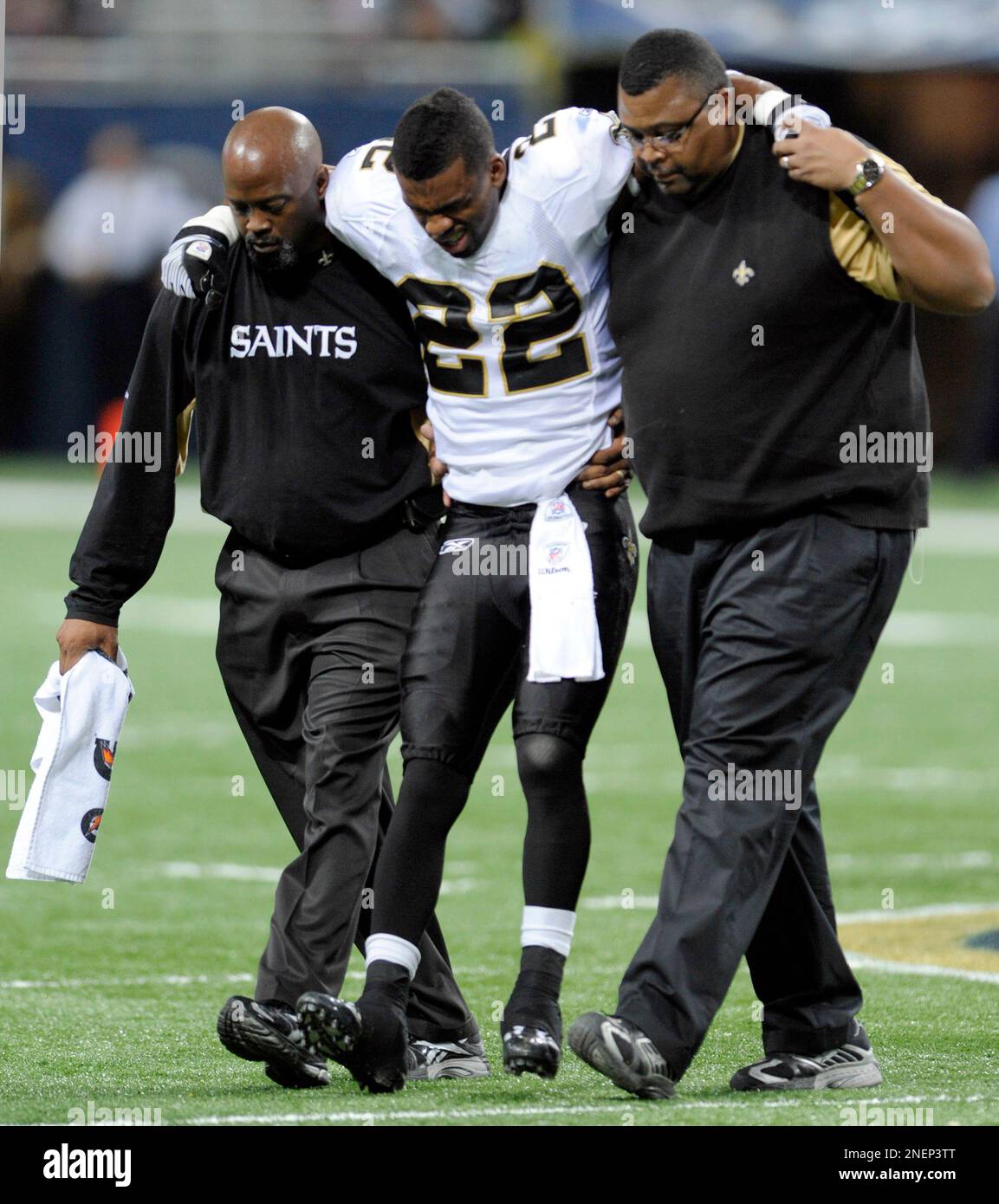 New Orleans Saints' Tracy Porter is helped off the field after being ...