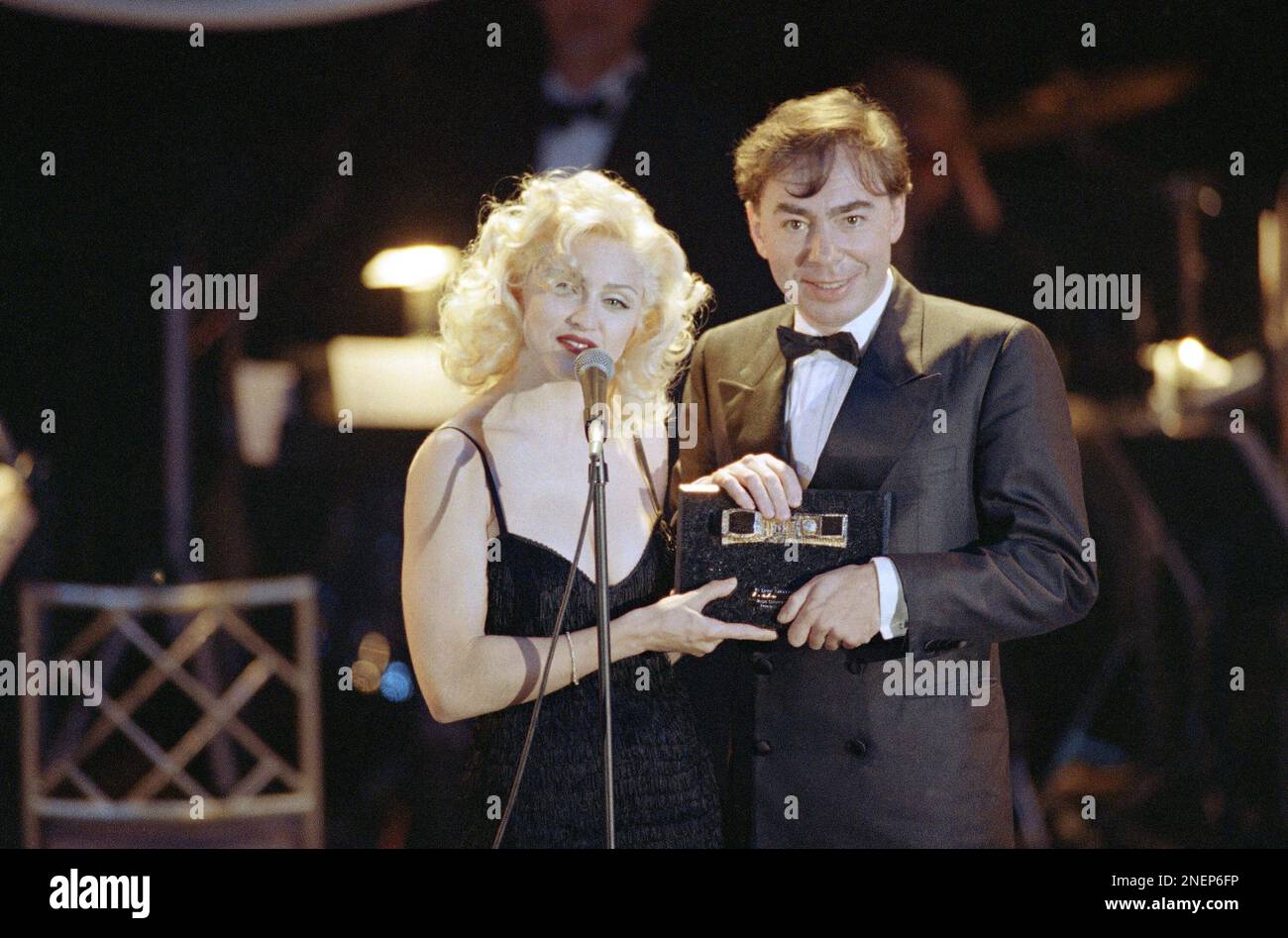 Singer/actress Madonna, left, presents Andrew Lloyd Webber with an ...