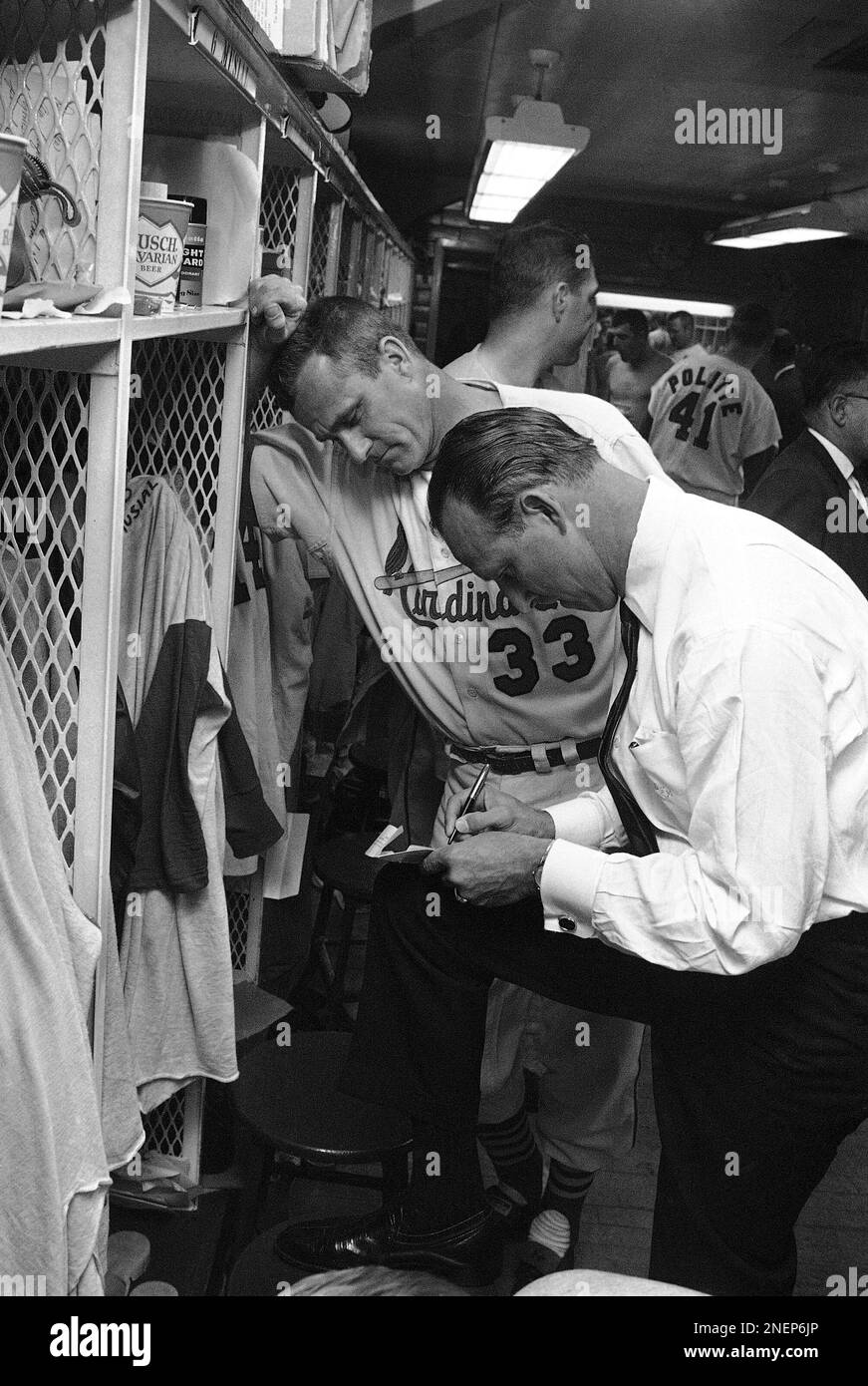 Lou Burdette, pitcher, gets an autograph from retiring Stan Musial in ...