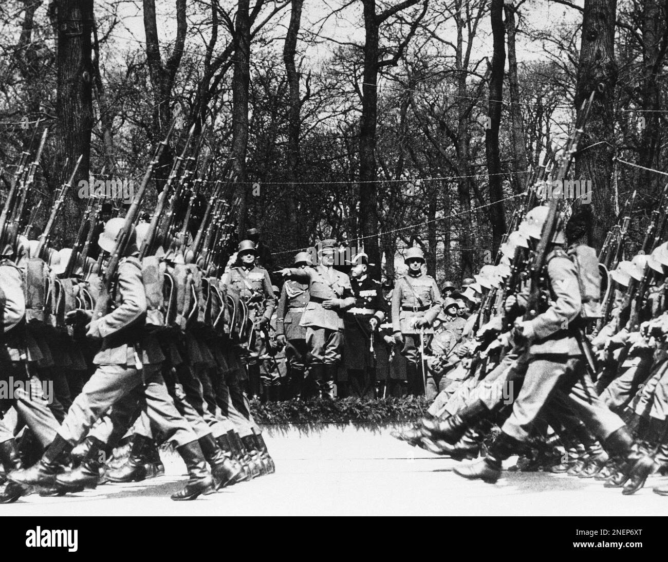 Germanys dictator responds with the Nazi salute as troops goose step by ...