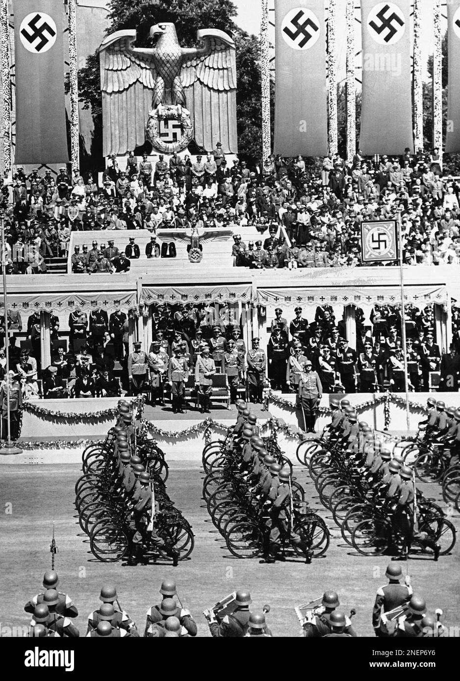 Bicycle detachments pass before Adolf Hitler during a military parade ...