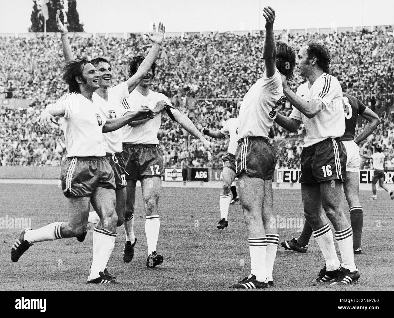 Poland's Andrzej Szarmach, second right, raises his arms in celebration ...