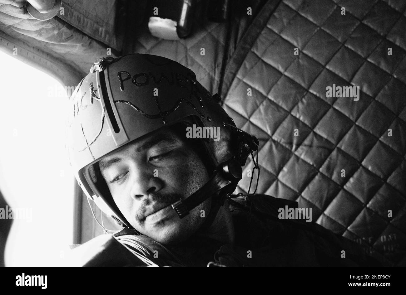 Sergeant G. Sanders from Detroit looks from the window of his Chinook ...
