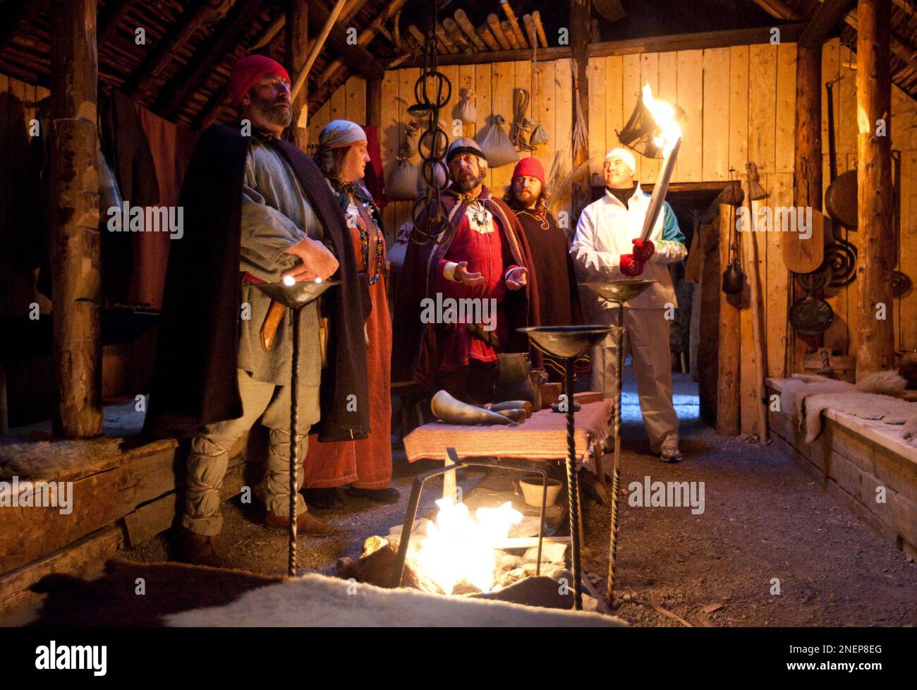 Viking impersonators give a speech as torchbearer Frank Humber holds ...