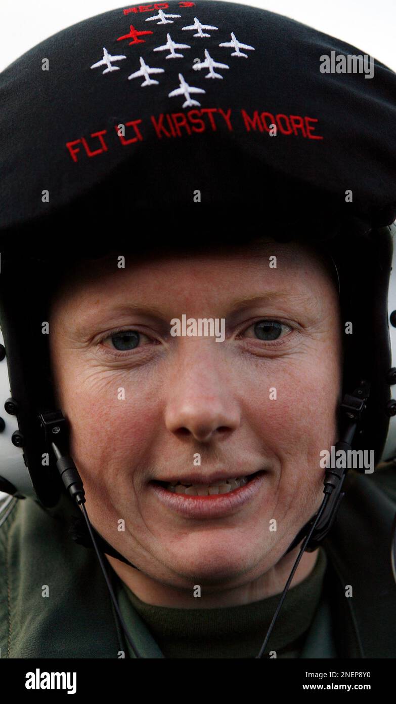 Red Arrow pilot Flight Lieutenant Moore looks on in her flight helmet ...