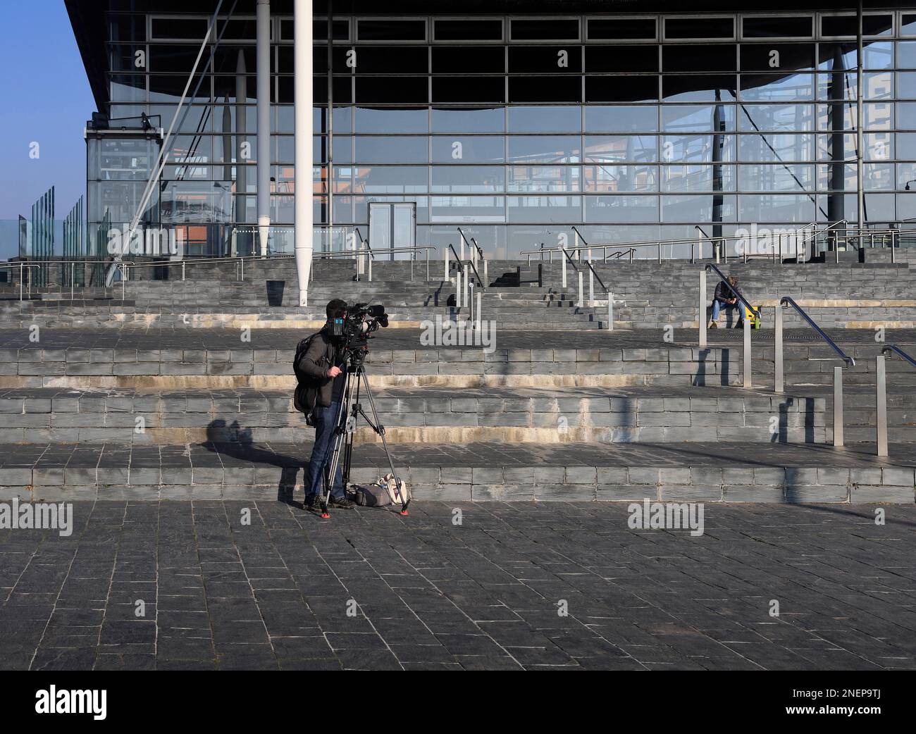 Filming a piece-to-camera outside the Senedd building, Cardiff Bay ...