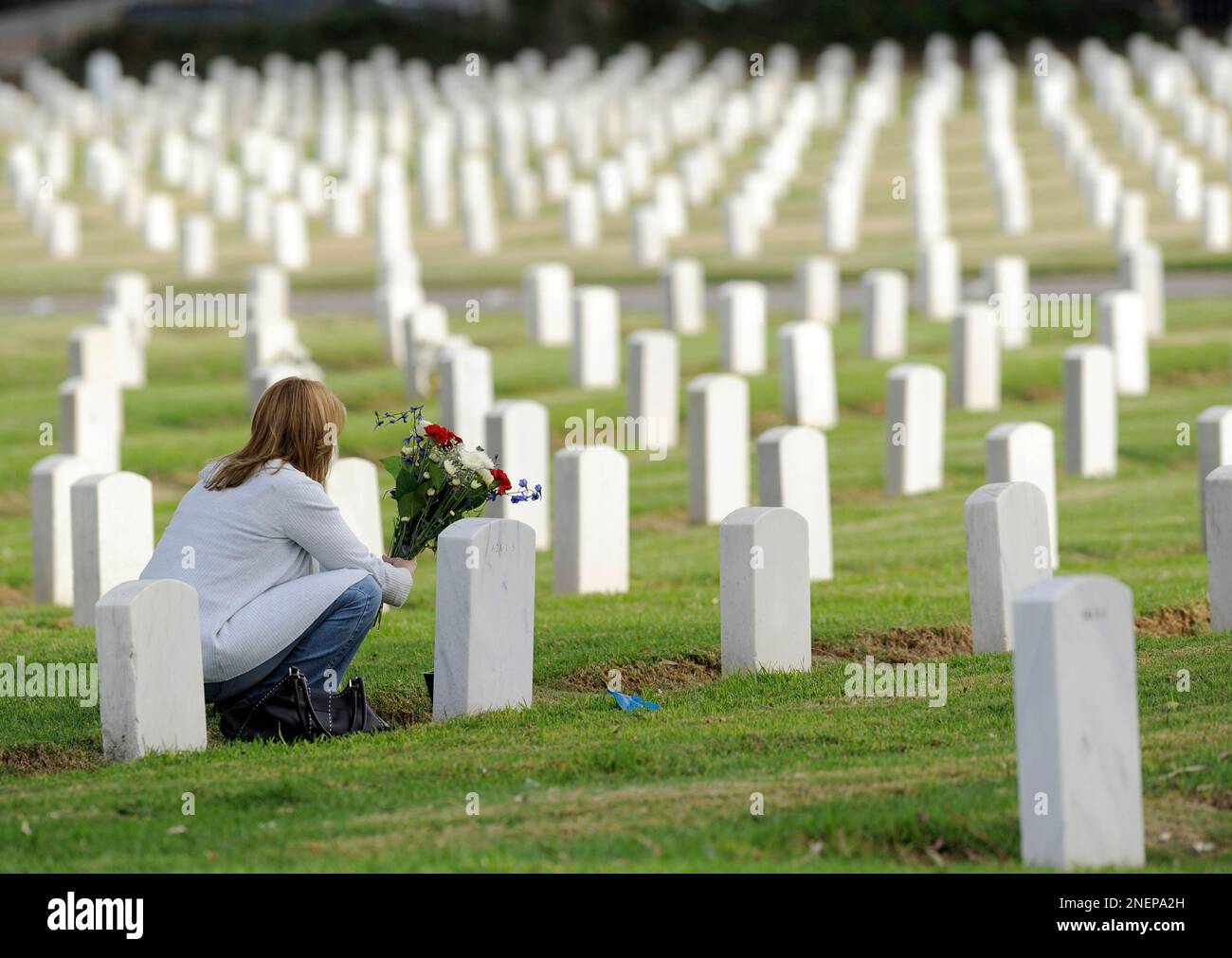 Lisa Smith of Los Angeles lays flowers down on the grave of her fiance ...