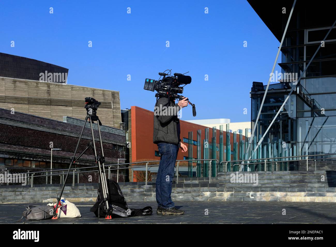 Filming a piece-to-camera outside the Senedd building, Cardiff Bay ...