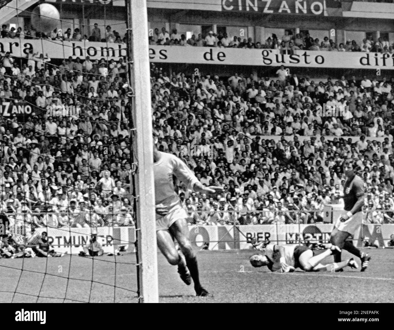 West Germany's Uwe Seeler, on ground, scores the second goal for his ...