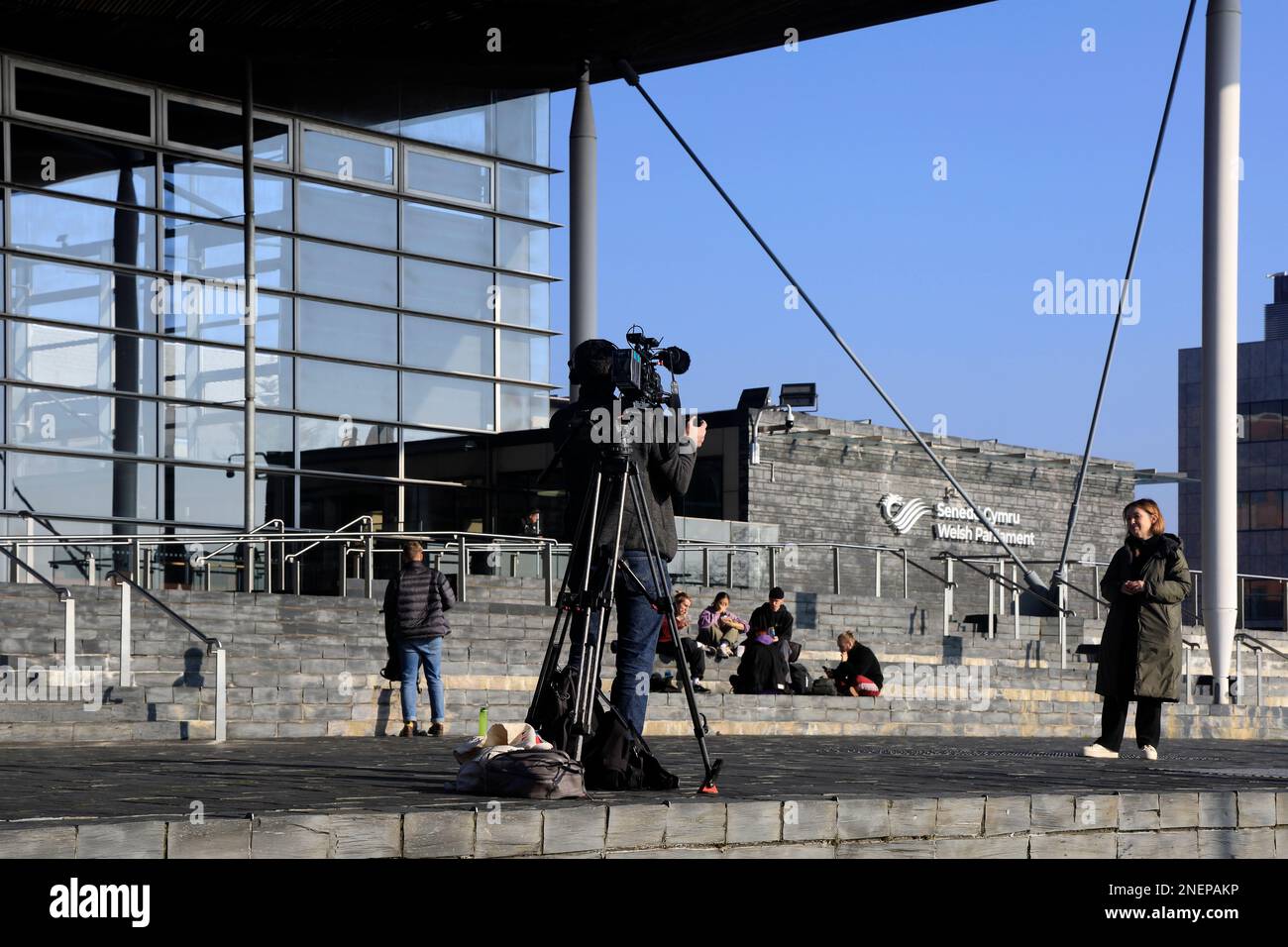 Filming a piece-to-camera outside the Senedd building, Cardiff Bay ...