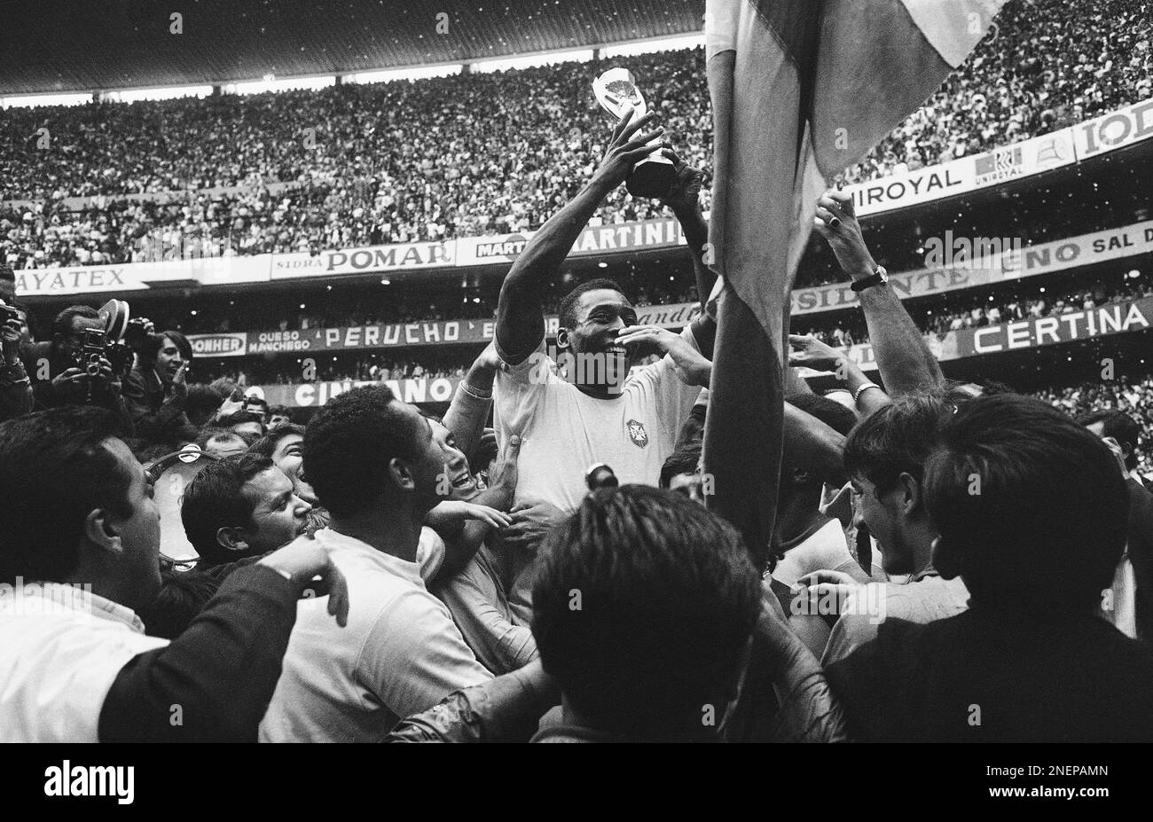 Brazil’s Pele has a big smile as he holds up the Jules Rimet Trophy ...